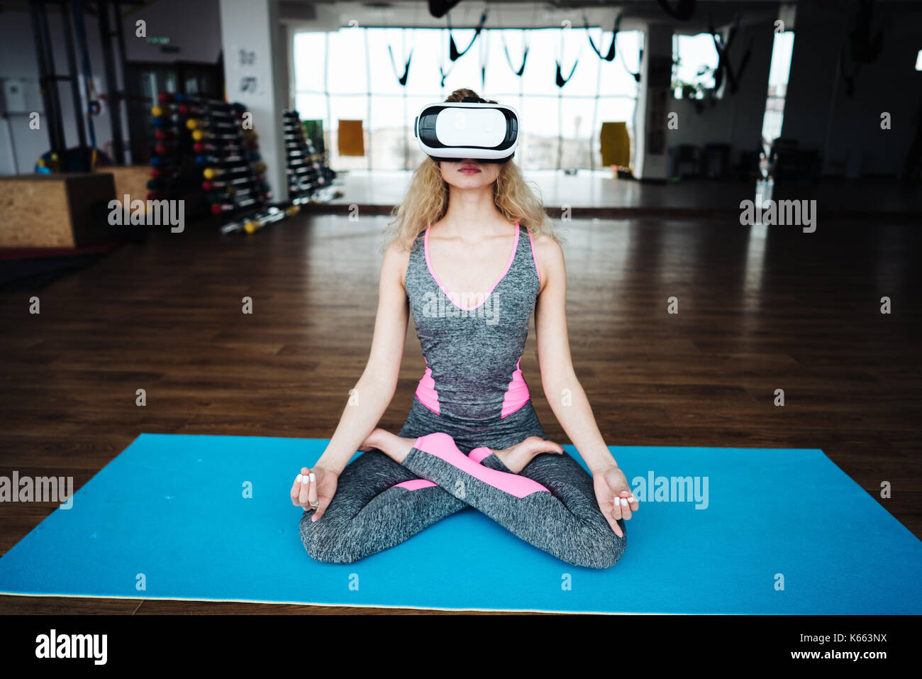 Woman in yoga class with VR helmet Stock Photo - Alamy