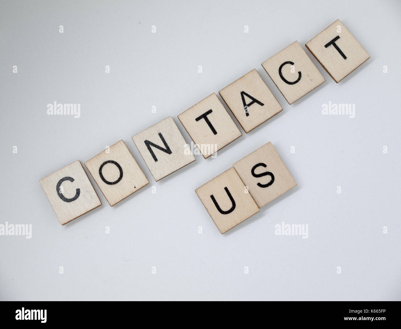 The words "Contact Us" spelled out with wooden letter tiles Stock Photo ...