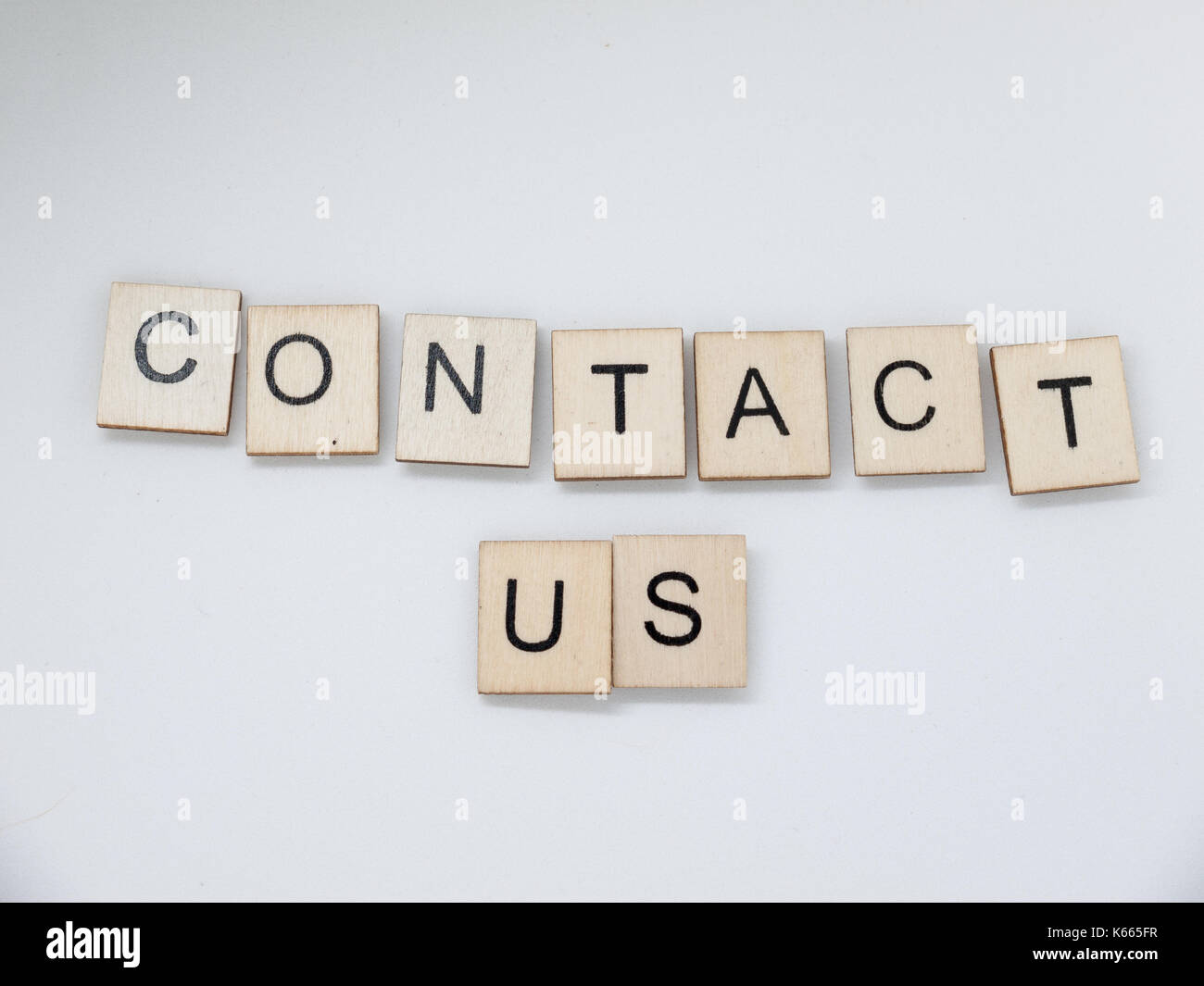 The words "Contact Us" spelled out with wooden letter tiles Stock Photo ...