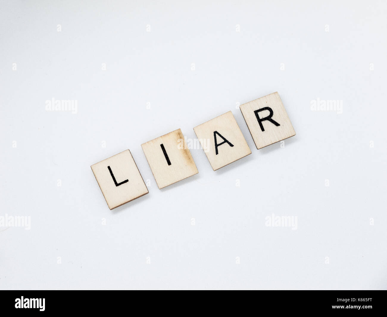 The word "Liar" spelled out with wooden letter tiles Stock Photo - Alamy
