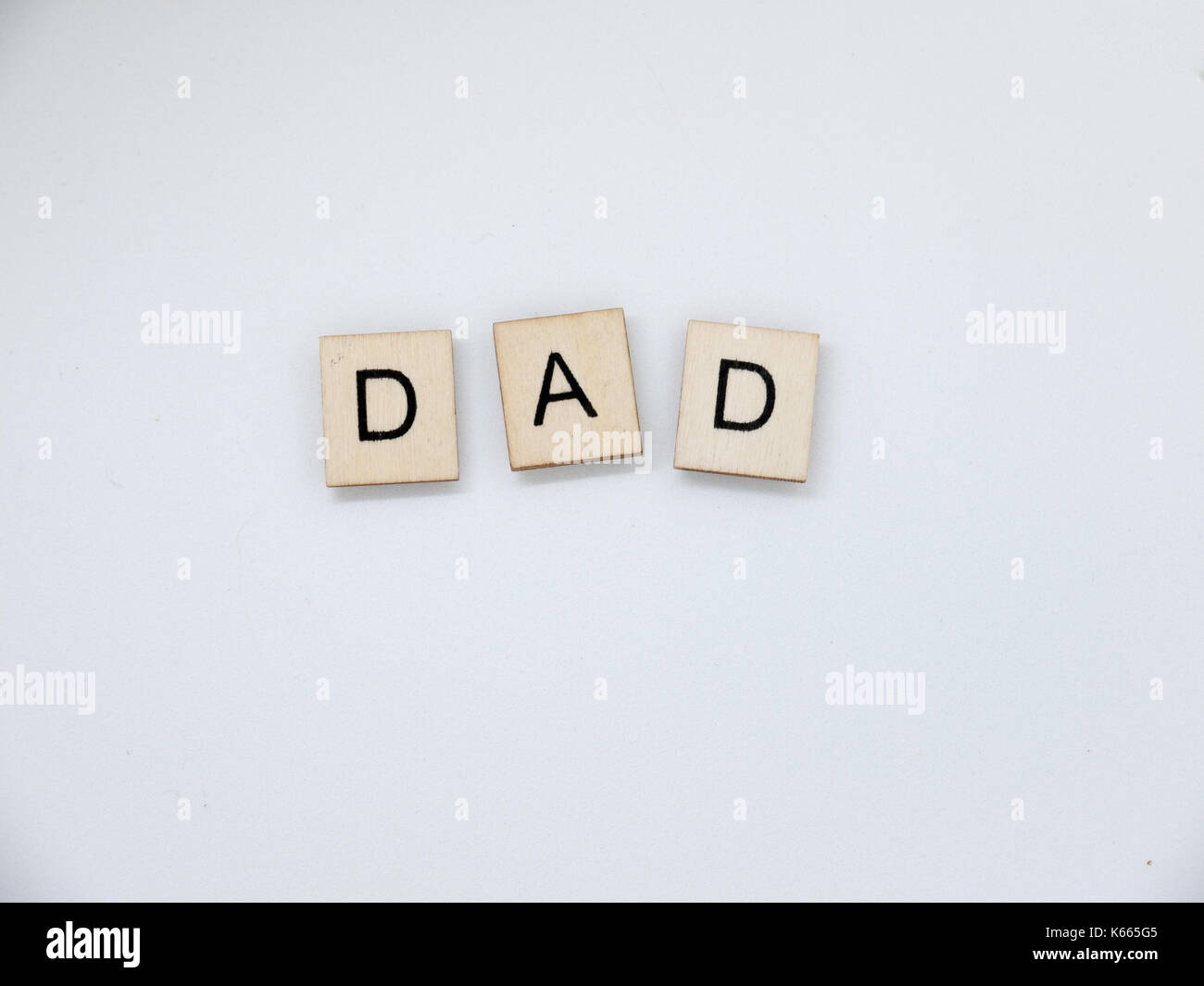The word "Dad" spelled out with wooden letter tiles Stock Photo - Alamy