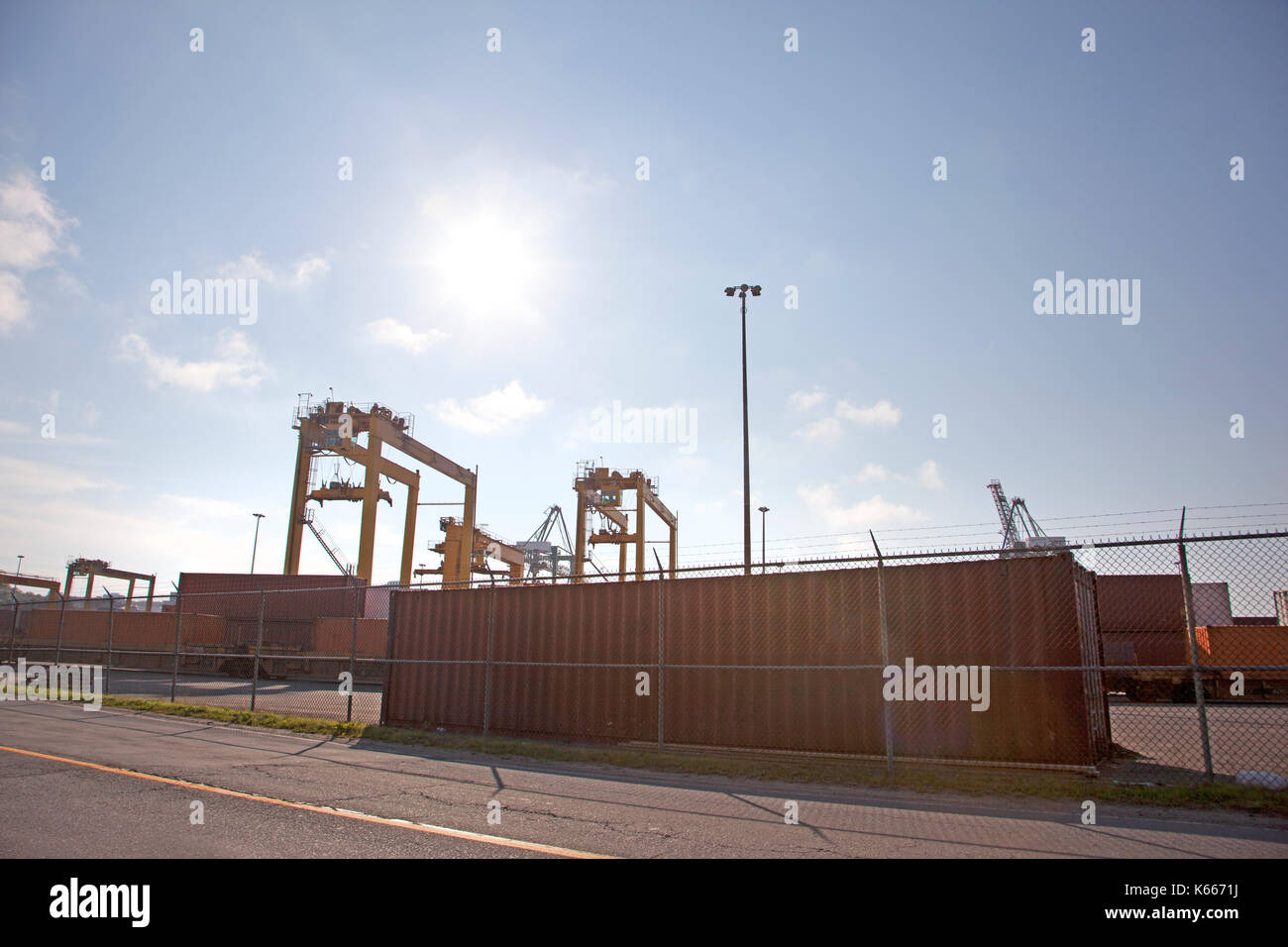 view of container pier or terminal, with shipping containers and crane ...