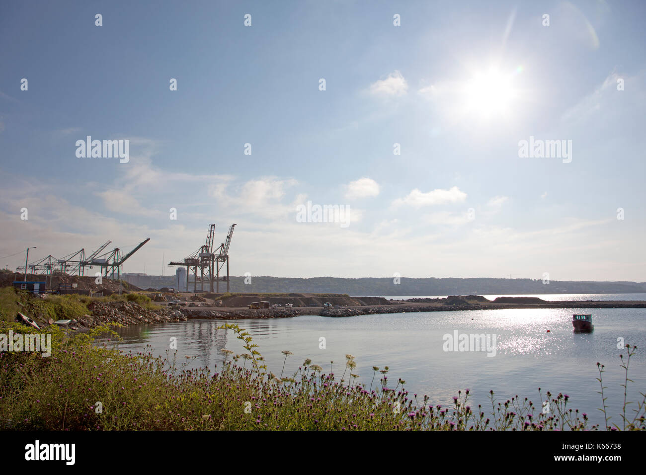 view of a container pier or port in a harbor, beside the ocean Stock ...