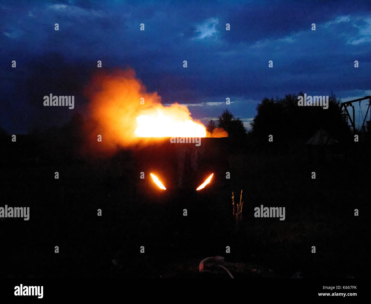 the fire burns in the night in a barrel, Russia Stock Photo - Alamy