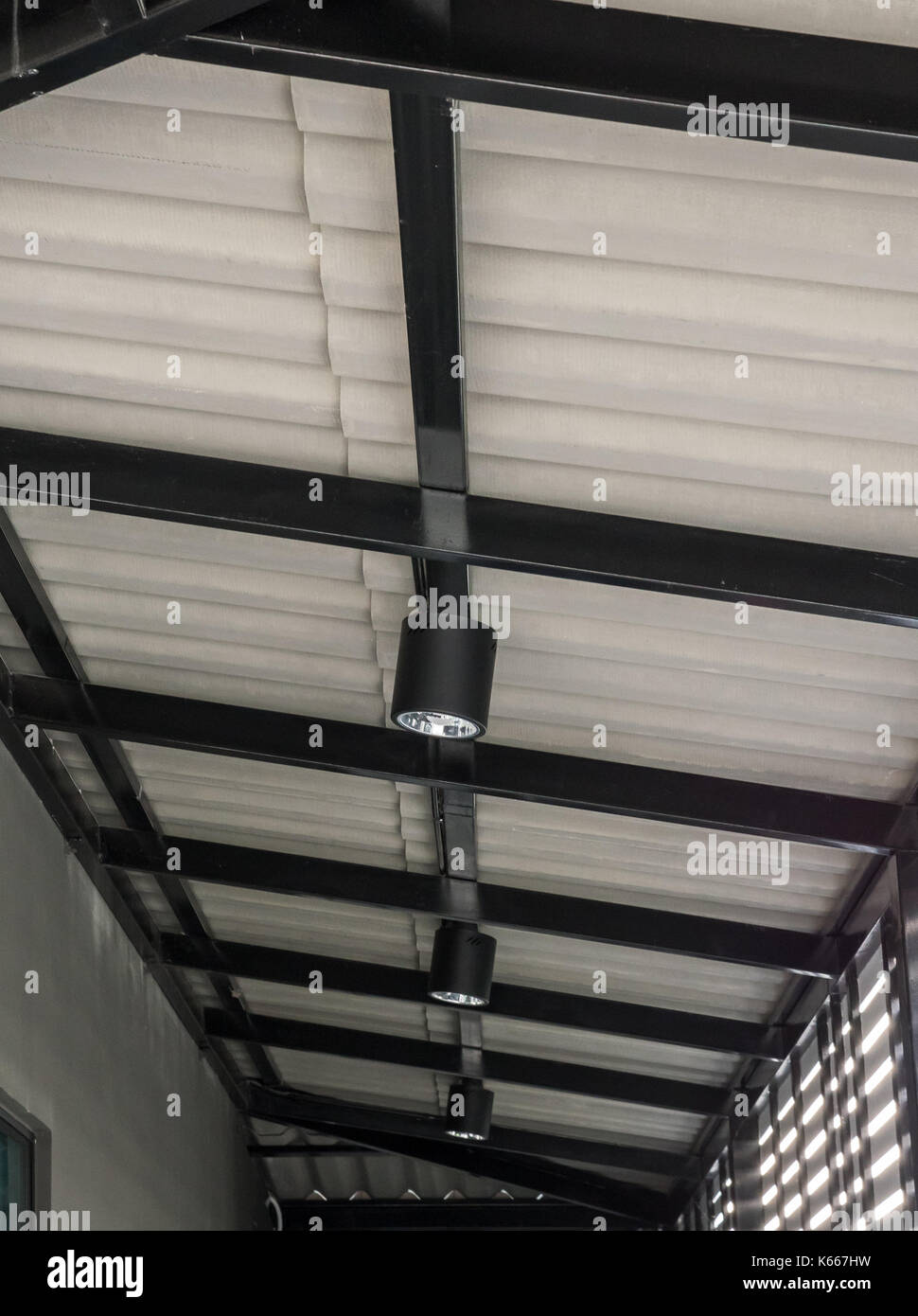 Moden black electrical lamp,hanging on the metal beam of the urban ...