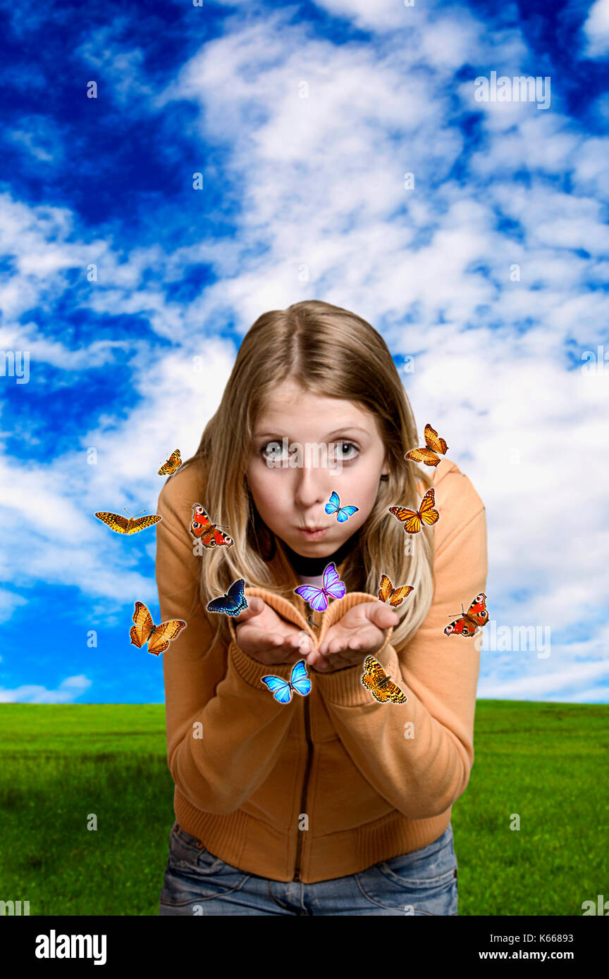 blond girl blowing off many colorful butterflies Stock Photo - Alamy