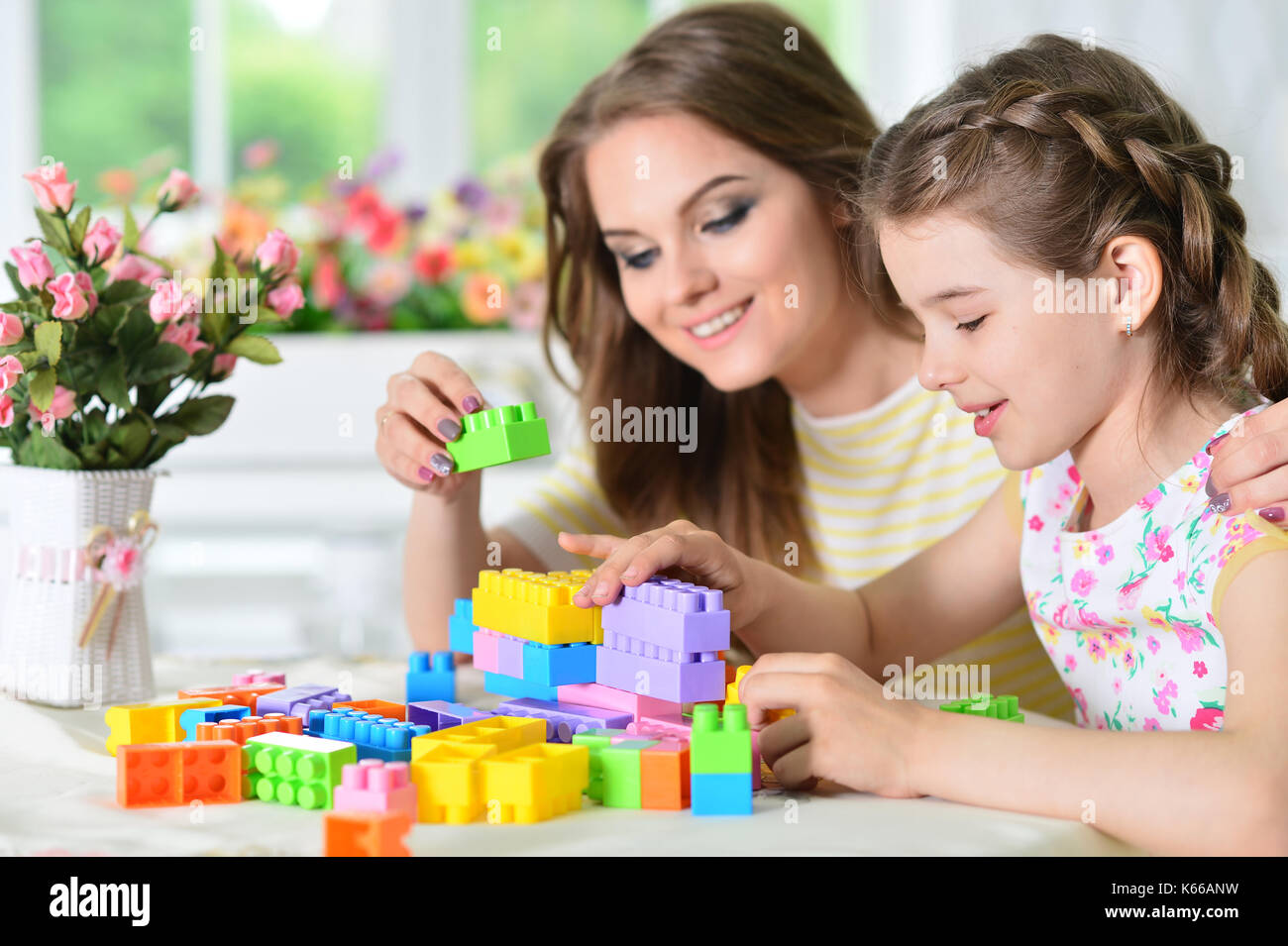 mother and daughter collecting blocks Stock Photo - Alamy
