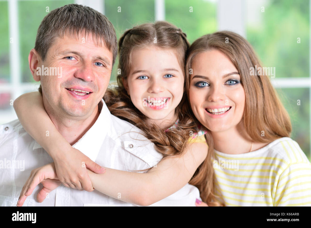 girl posing with her parents Stock Photo - Alamy