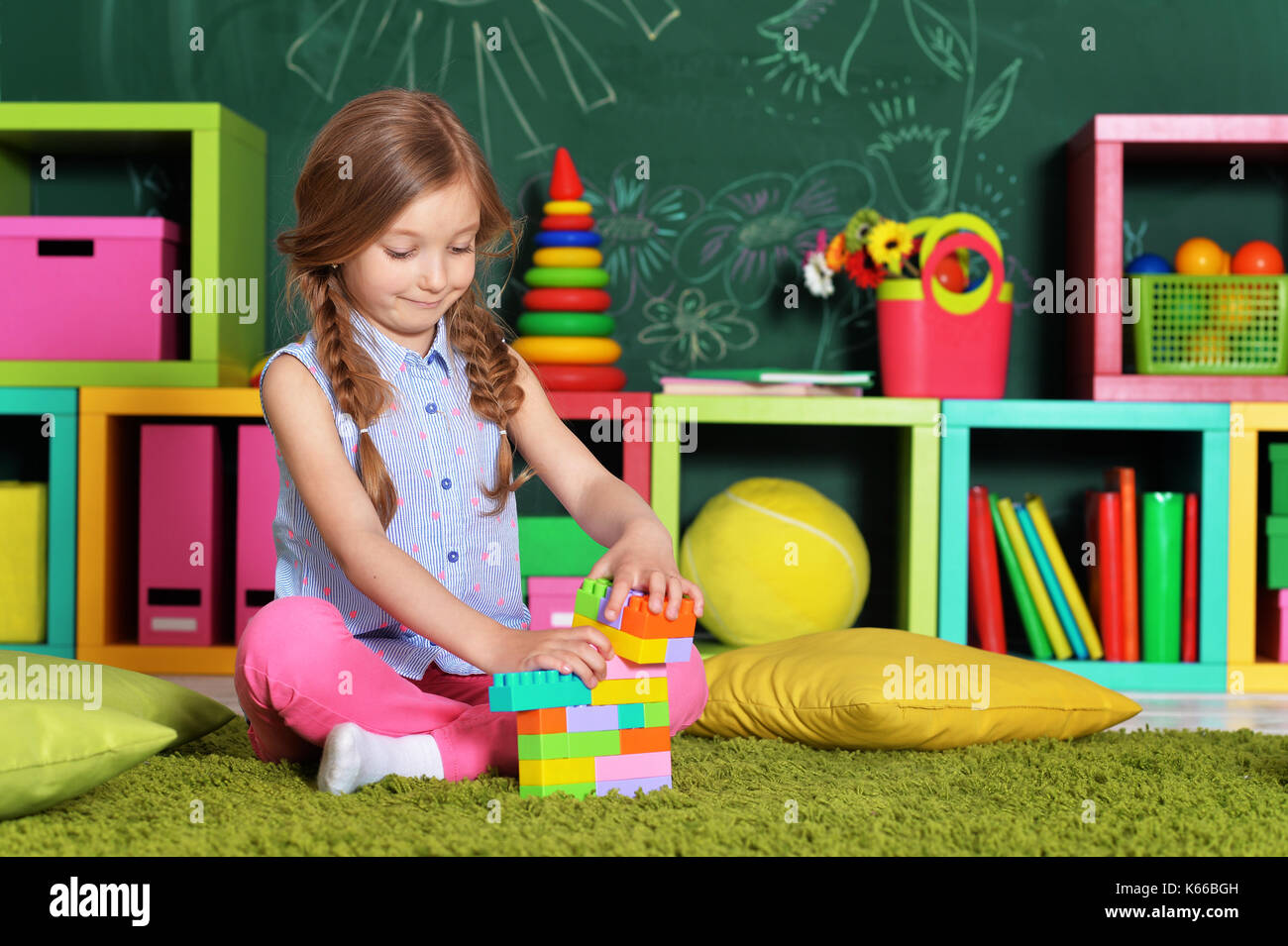 little girl with colorful plastic blocks Stock Photo - Alamy