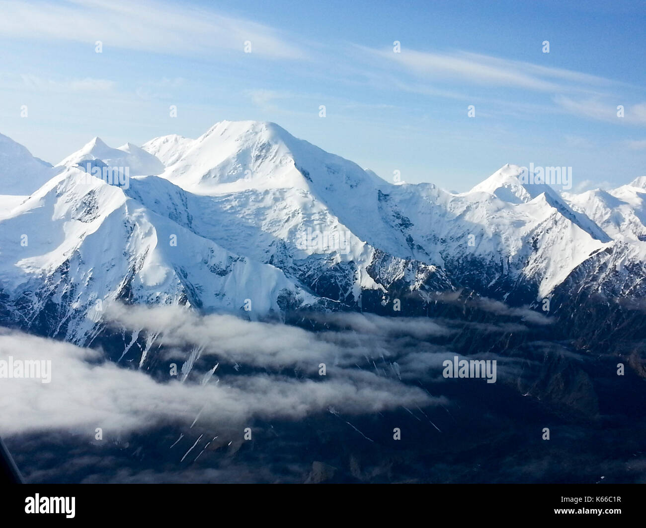 AERIAL VIEW FROM TOURING AIRPLANE OF SNOW CAPPED MOUNTAINS, ALASKA ...