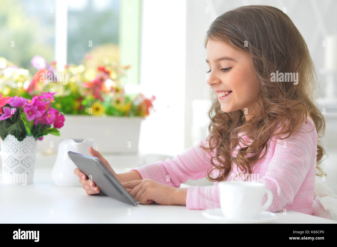Beautiful little girl with tablet pc Stock Photo - Alamy