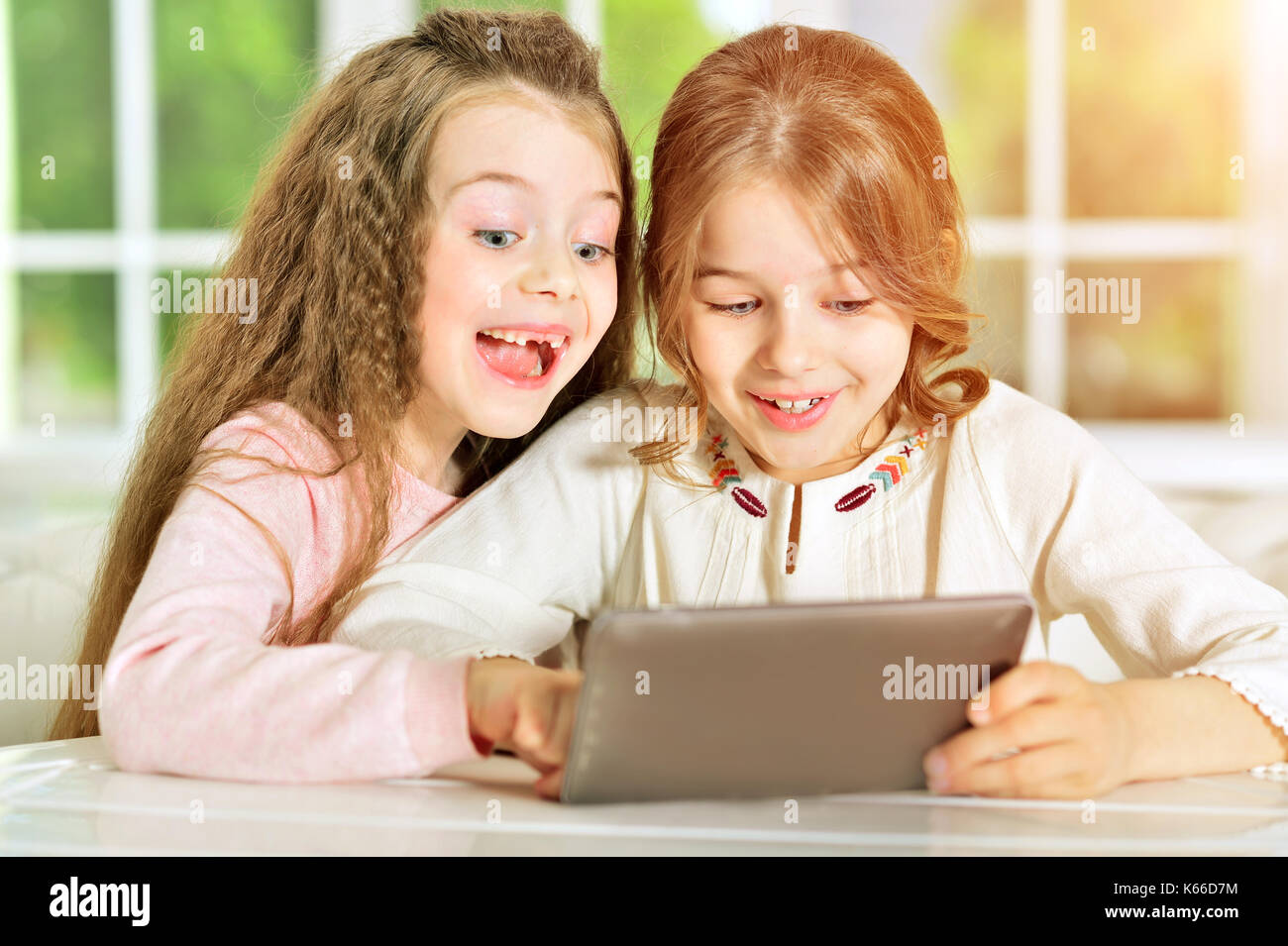 little girls using tablet Stock Photo - Alamy