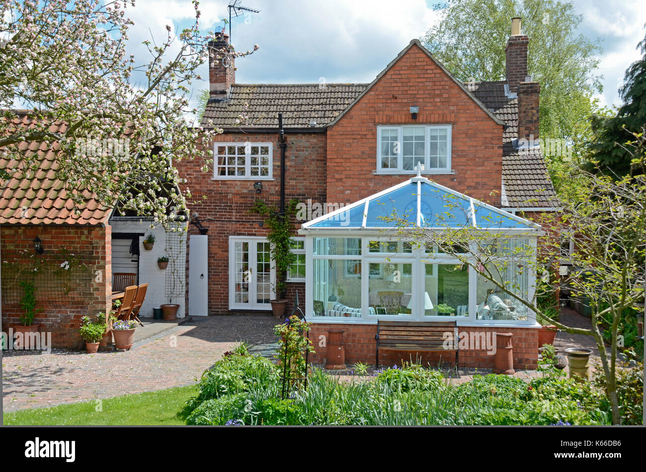 Conservatory to rear of English cottage garden Stock Photo - Alamy