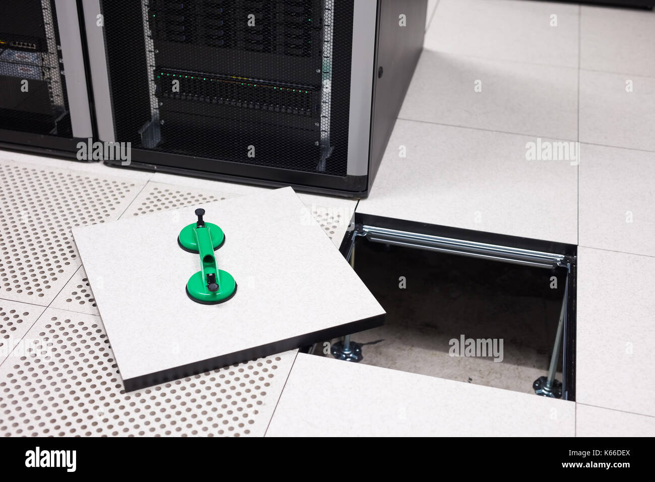 High angle view of lifted floor tile with vacuum suction cups in ...