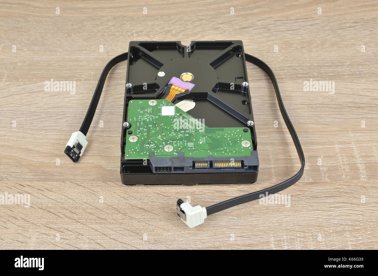 Hard disk and its SATA cable on a wooden surface Stock Photo - Alamy