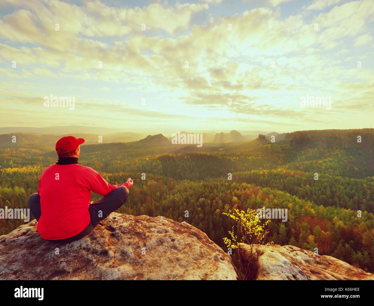 Single man tourist sit on rock empire. View point with exposed rocky ...