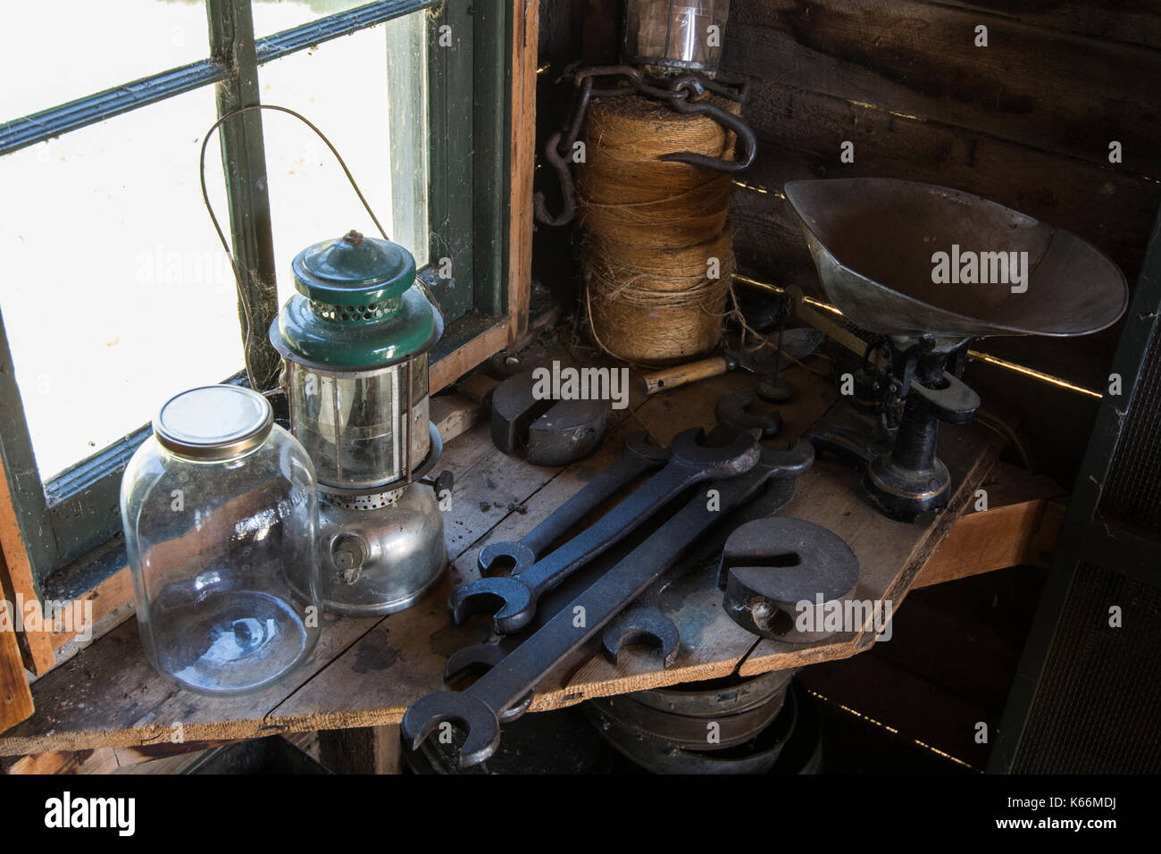 Assortment of Vintage tools by a window with lanterns and a scale Stock ...