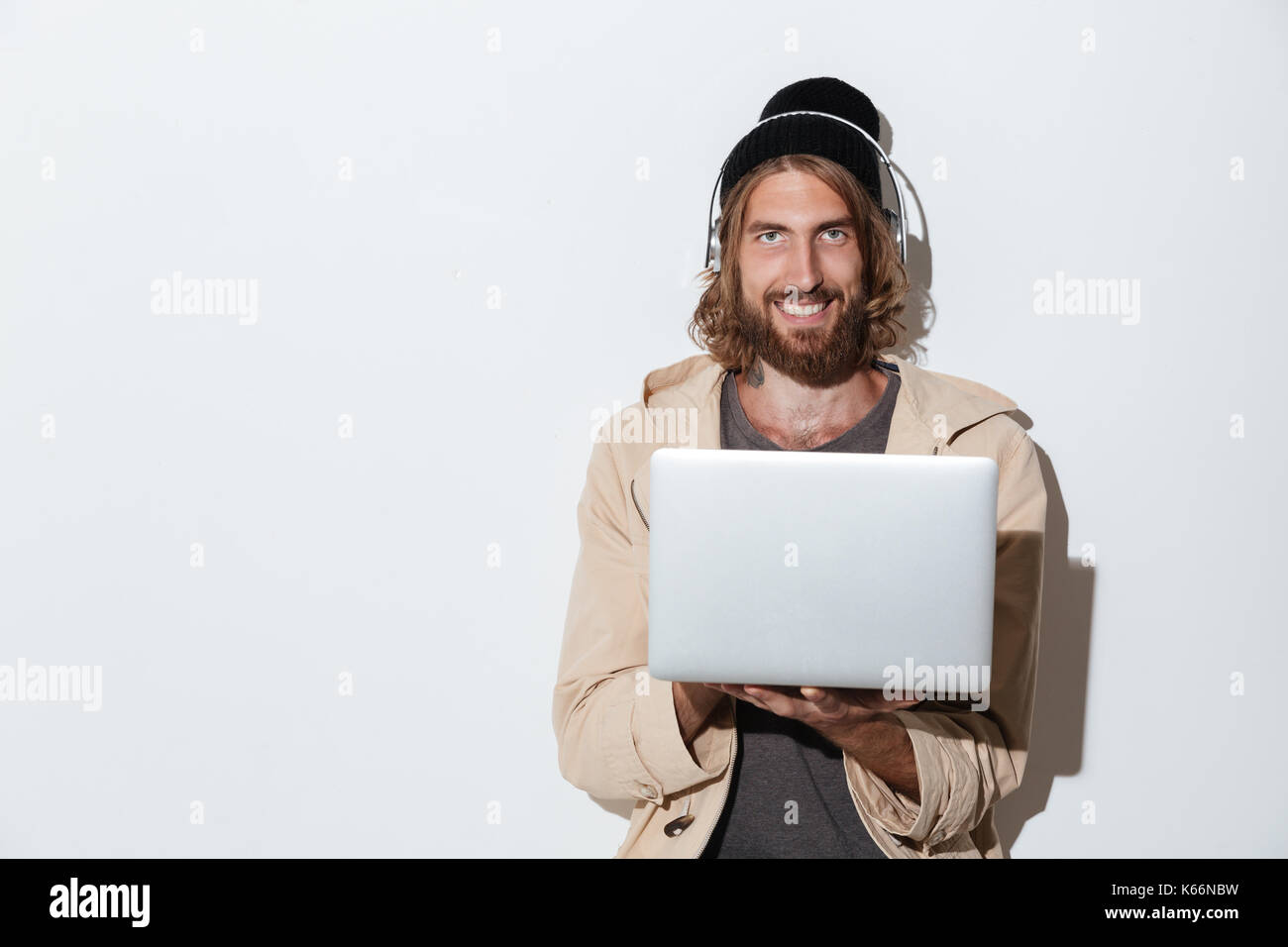 Image of a happy hipster man looking camera isolated over wall ...