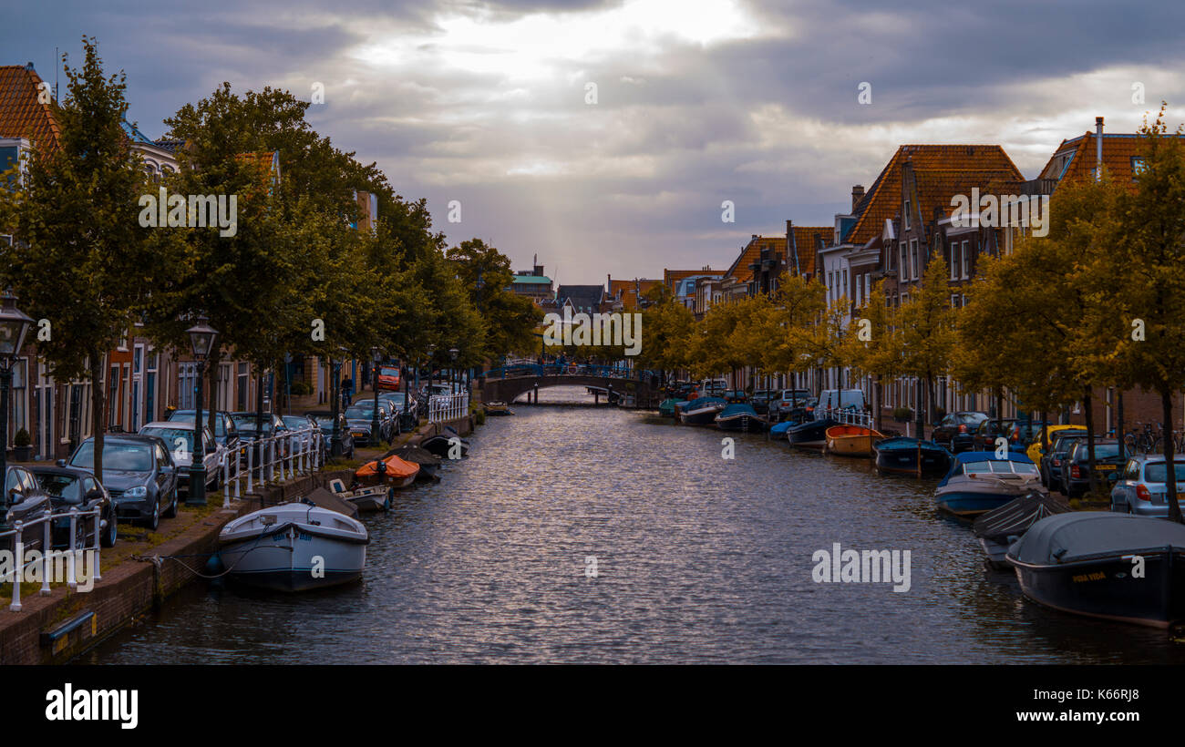 Water canals in Leiden, The Netherlands with boats, trees, old dutch ...
