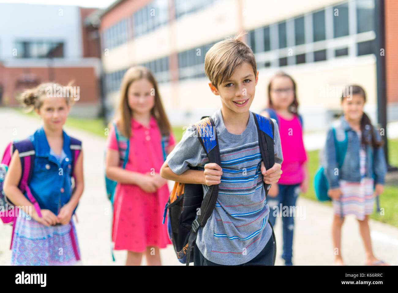 Great Portrait Of School Pupil Outside Classroom Carrying Bags Stock ...