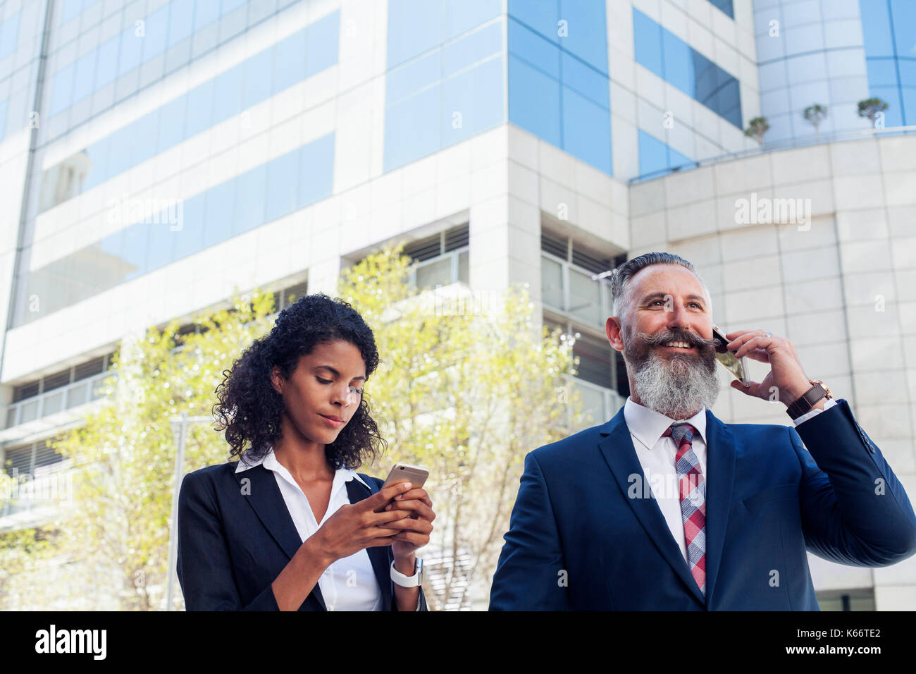 Mature businessman using two mobile phones hi-res stock photography and ...