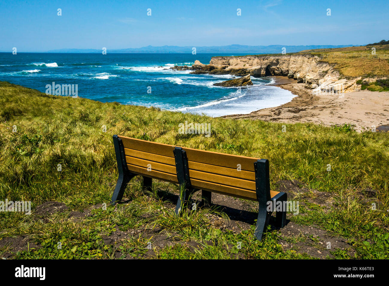 Bench overlooking ocean cove Stock Photo - Alamy