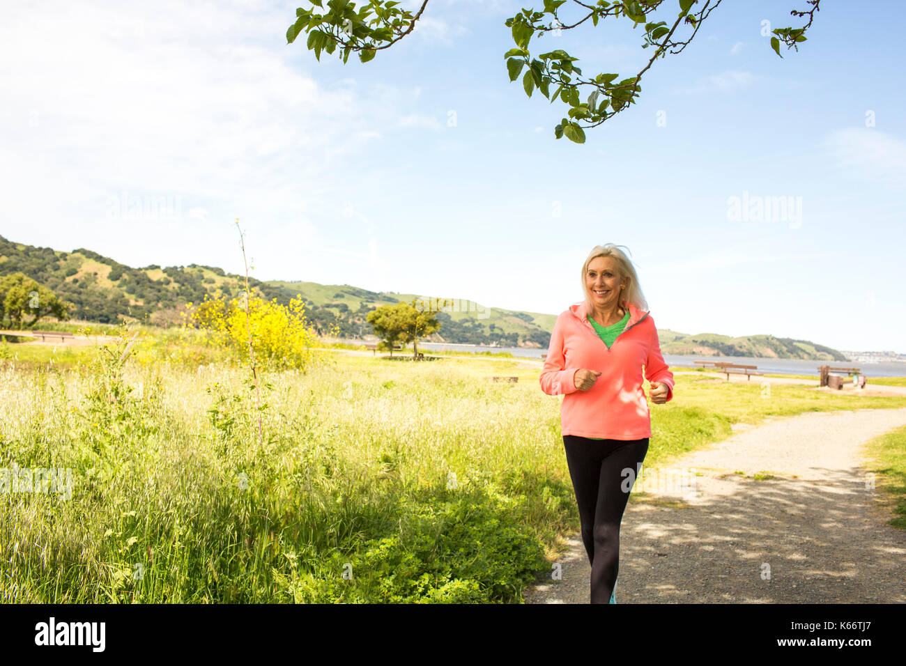 Woman trail running at coast hi-res stock photography and images - Alamy