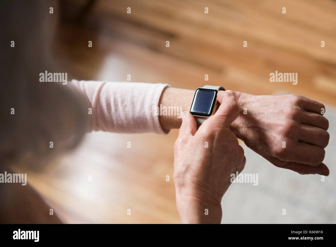 Older woman checking smart watch Stock Photo - Alamy