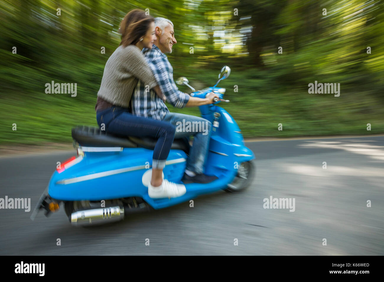 Woman riding scooter around city hi-res stock photography and images ...