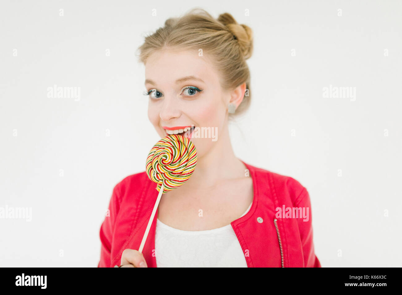 Middle Eastern woman eating lollipop Stock Photo - Alamy