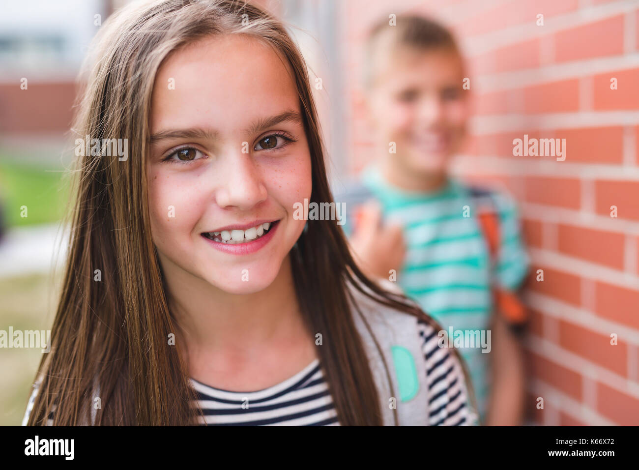 Portrait of two school friends with backpacks Stock Photo - Alamy