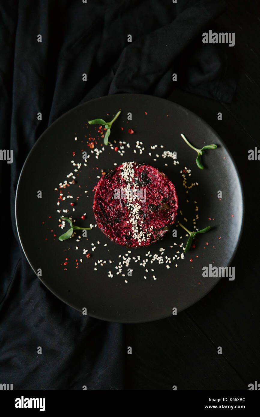 Sesame seeds and garnish on red food on plate Stock Photo - Alamy