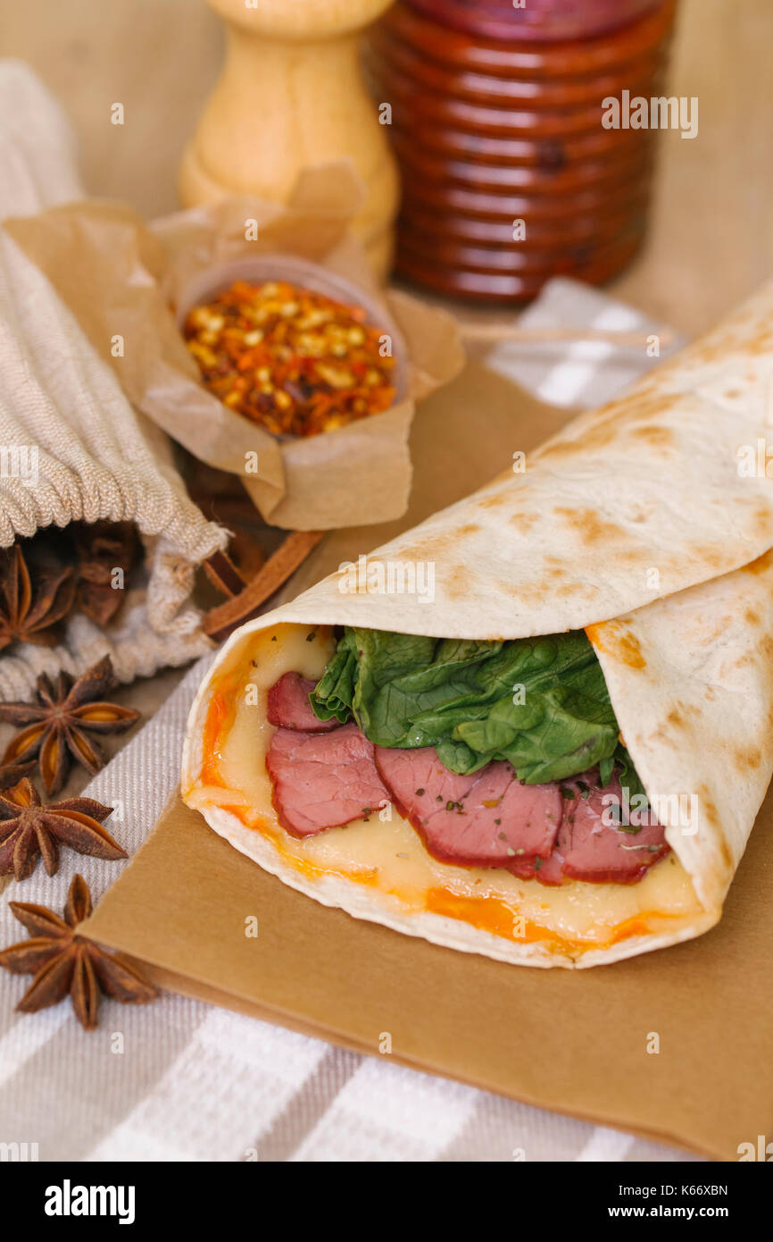 Meat and melted cheese in wrap Stock Photo - Alamy