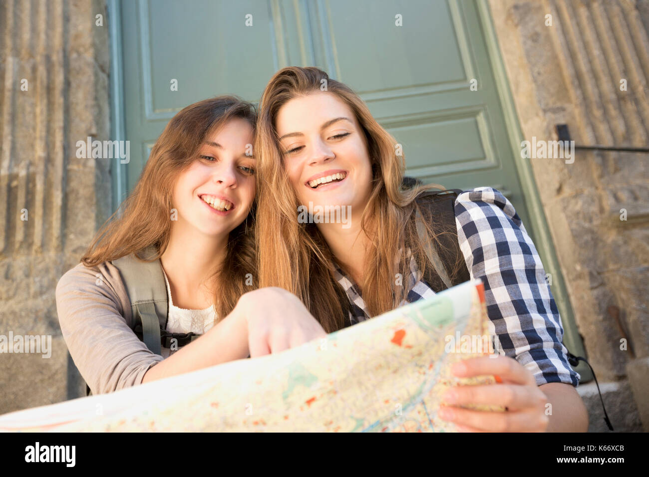 Caucasian women reading map Stock Photo - Alamy