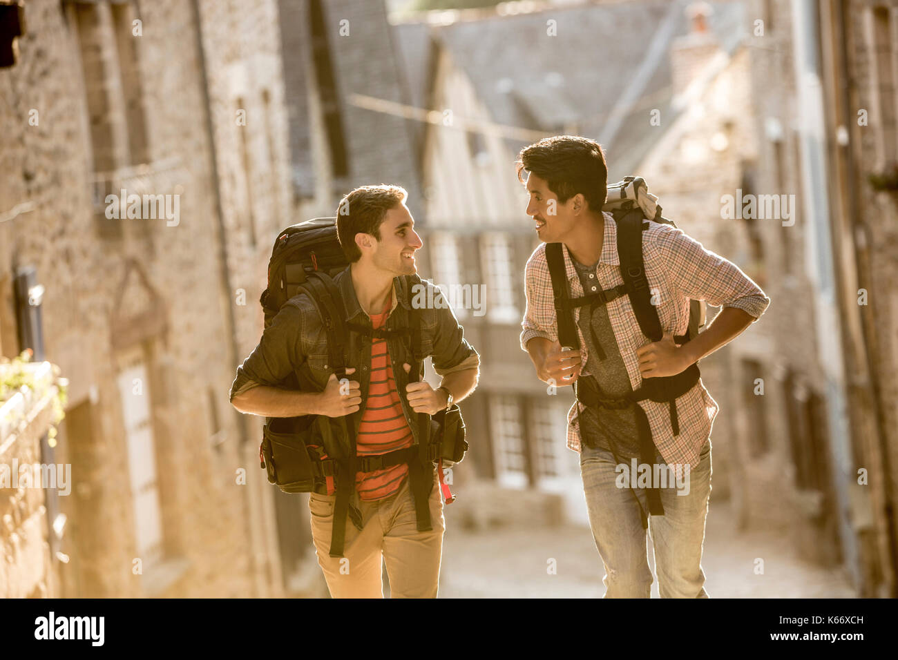 Men backpacking in city Stock Photo - Alamy