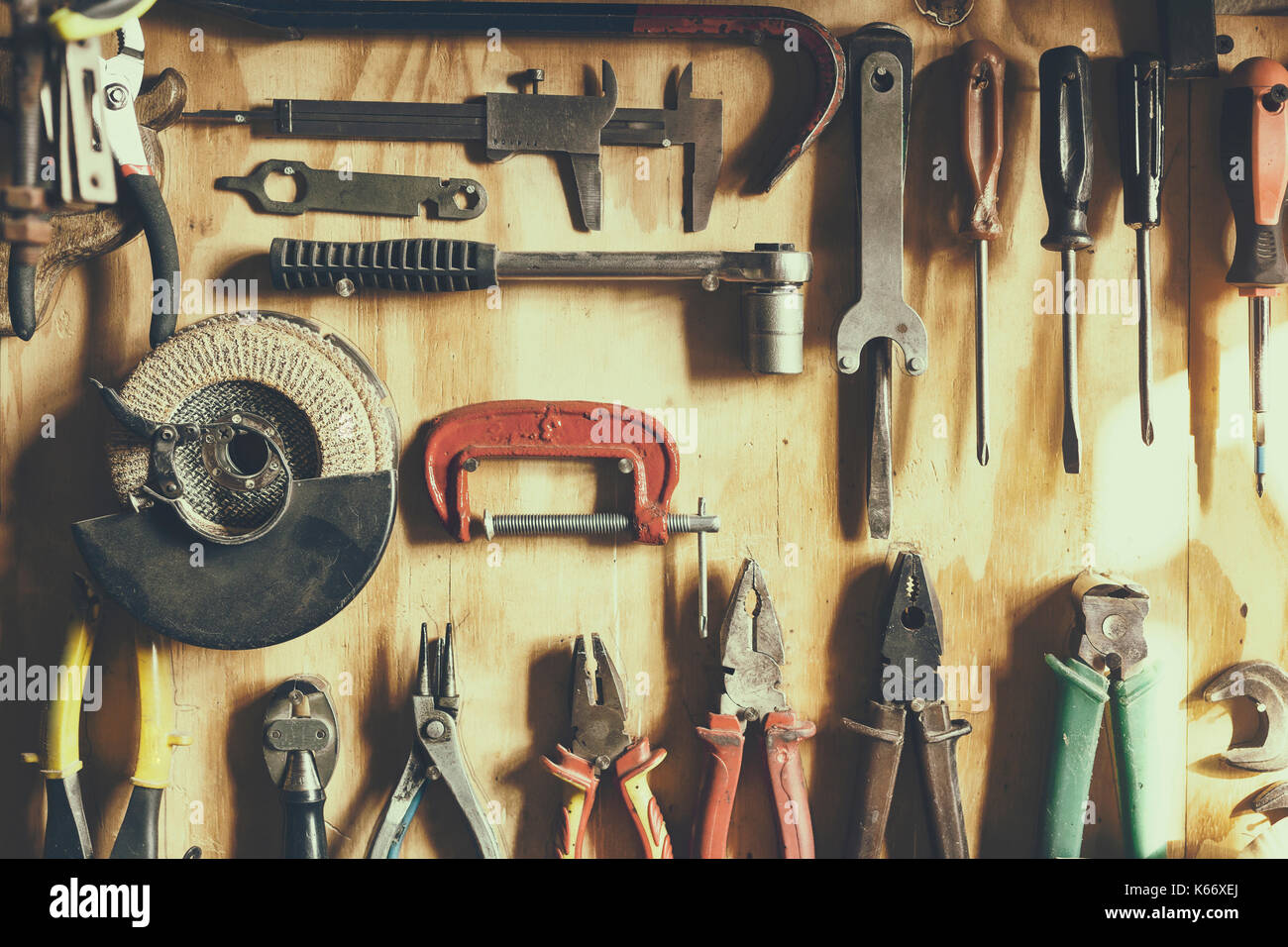 Tools hanging on wooden wall Stock Photo - Alamy