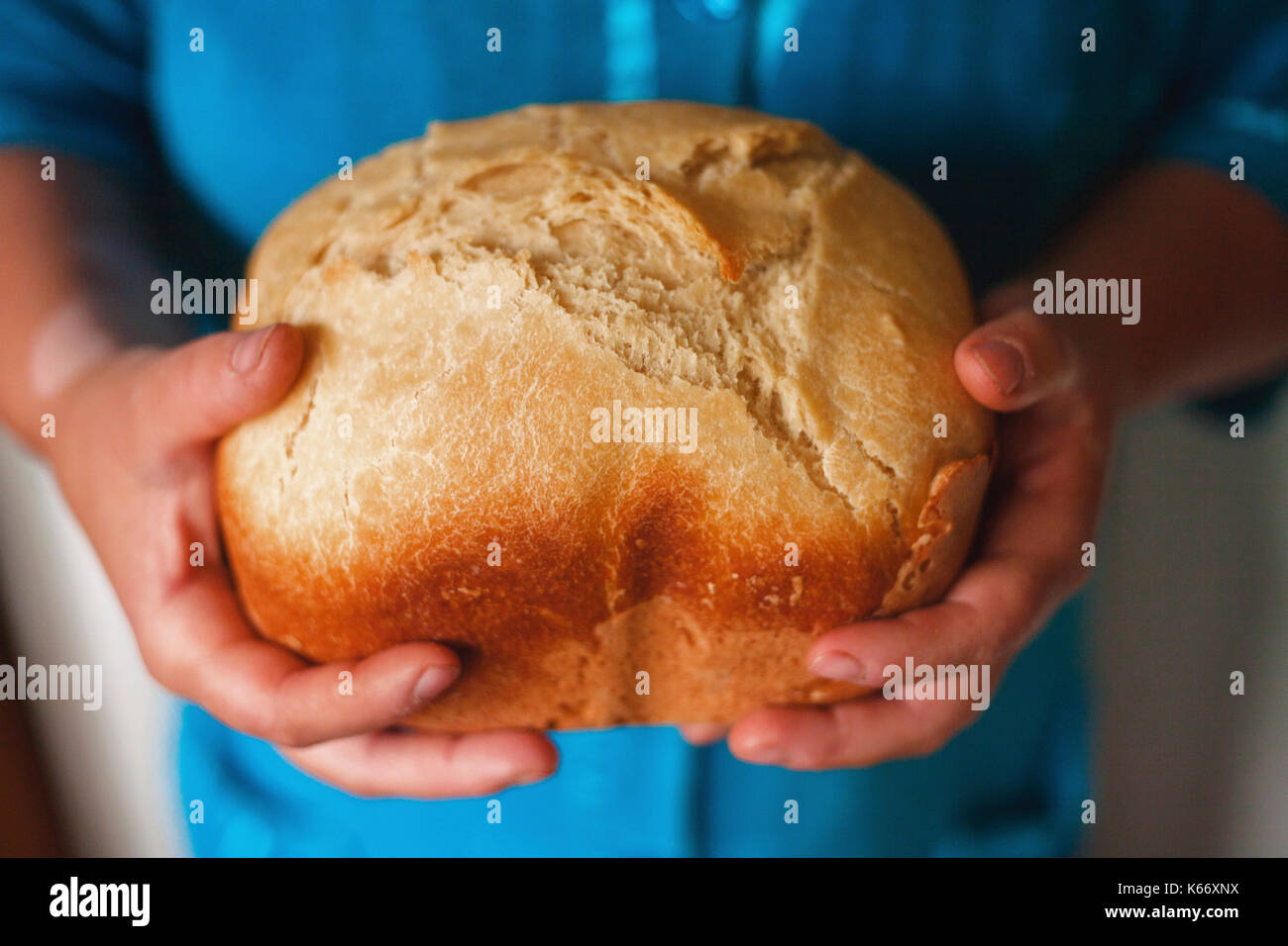 Hands holding loaf of bread Stock Photo - Alamy