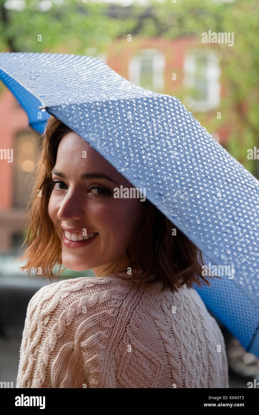 Holding an umbrella over her head hi-res stock photography and images ...