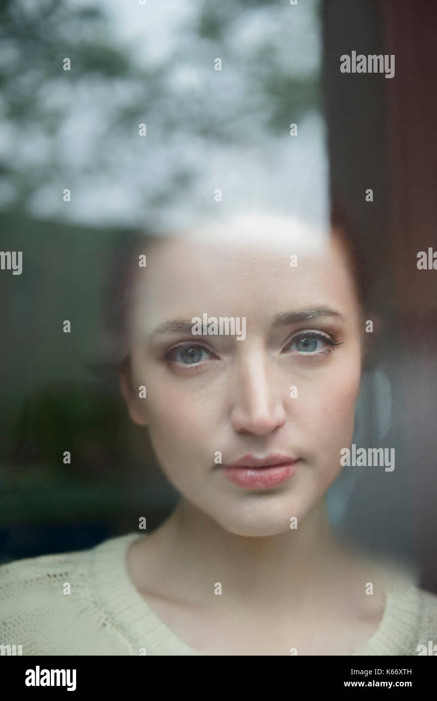 Serious Caucasian woman behind foggy window Stock Photo - Alamy