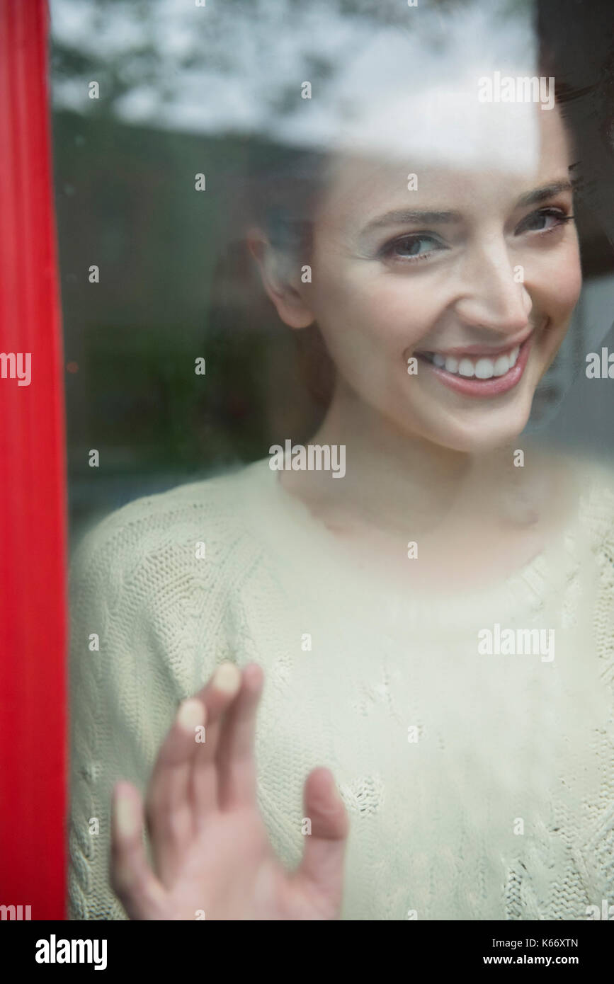 Caucasian woman smiling behind foggy window Stock Photo - Alamy