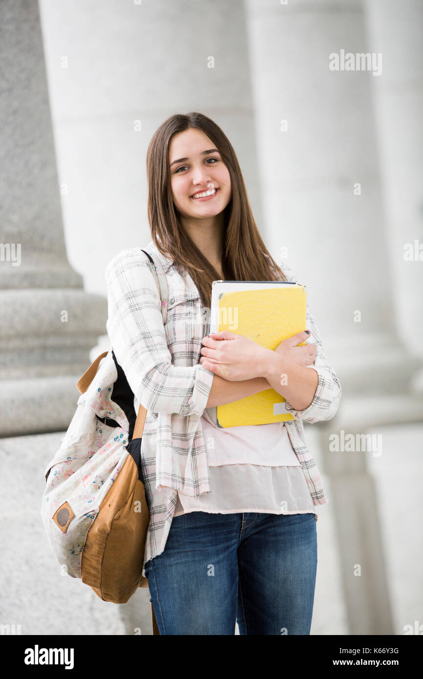 Caucasian woman carrying school notebook Stock Photo - Alamy