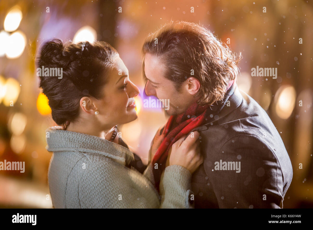 Caucasian couple hugging outdoors at night Stock Photo - Alamy