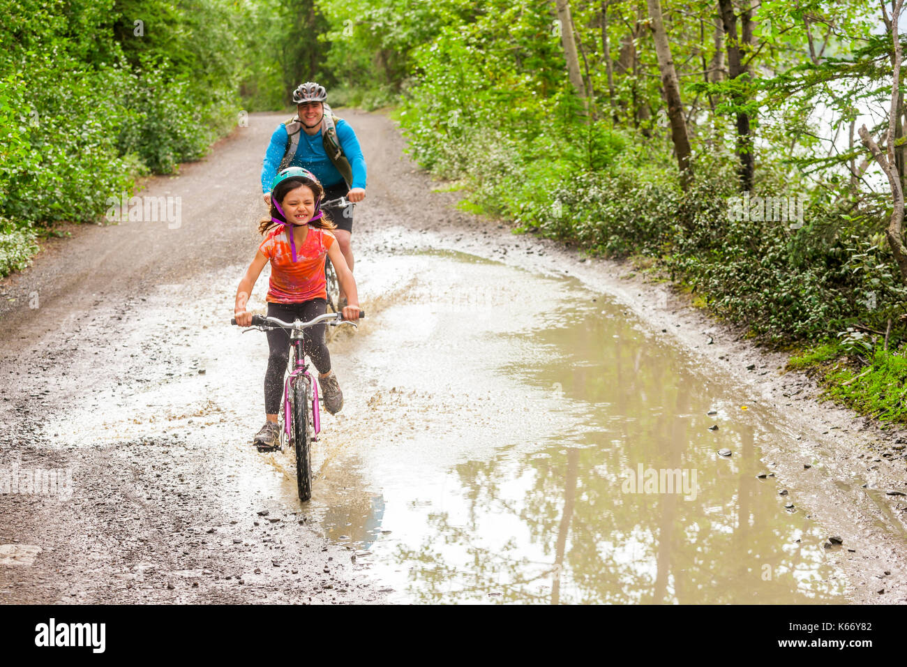 Multicultural family riding bicycles hi-res stock photography and ...