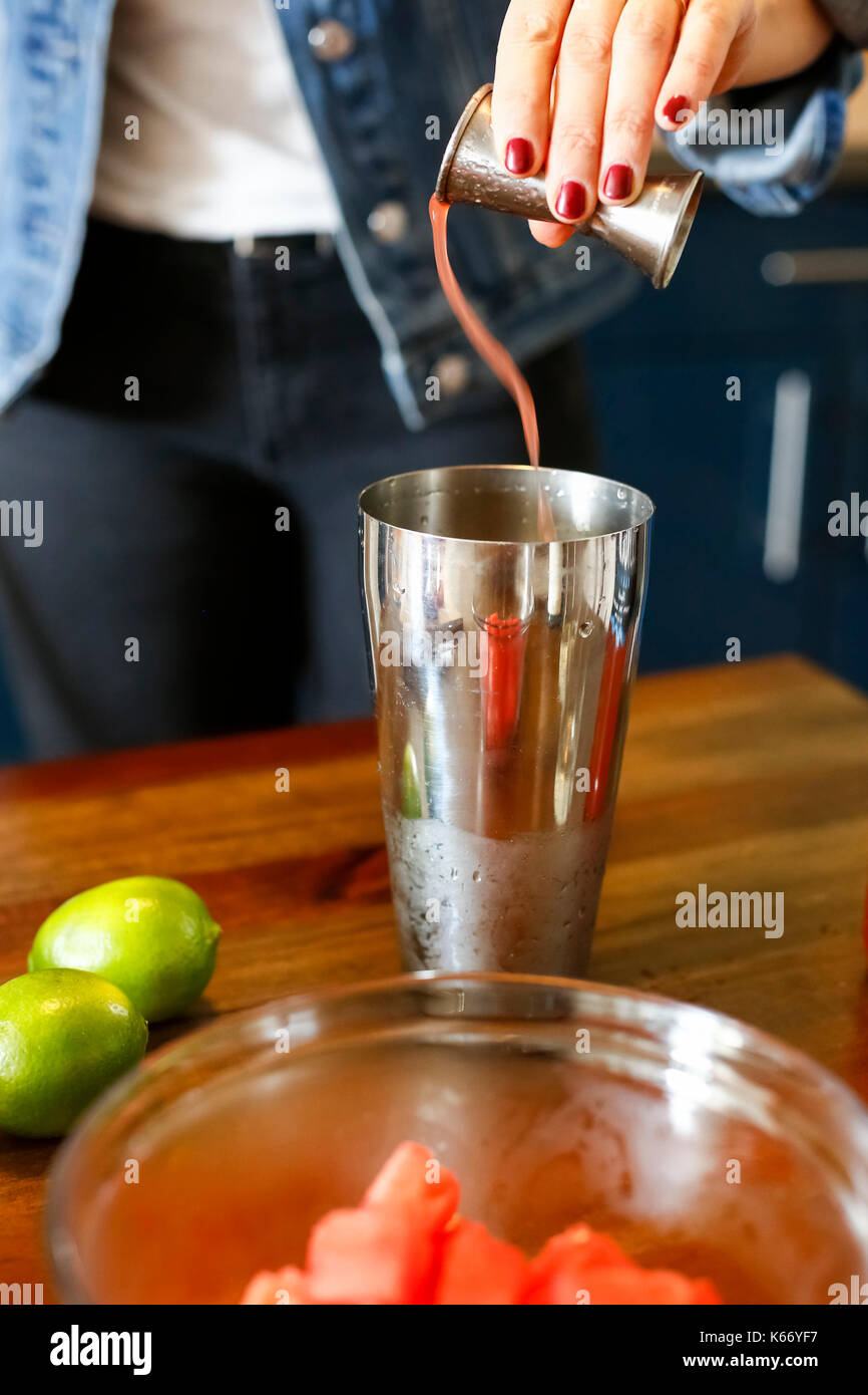 Woman pouring liquid into cocktail shaker Stock Photo - Alamy