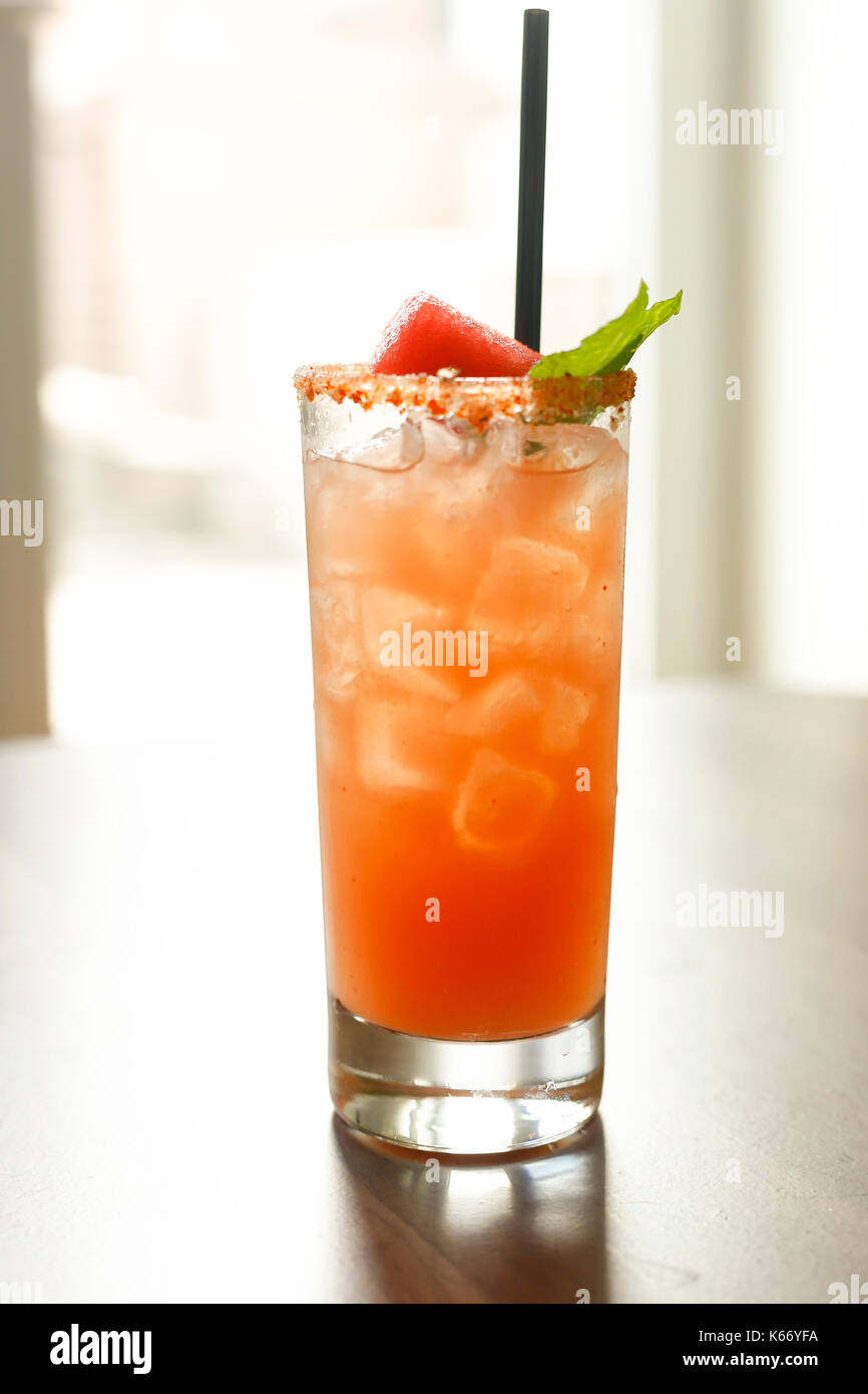 Cocktail in glass with straw Stock Photo - Alamy