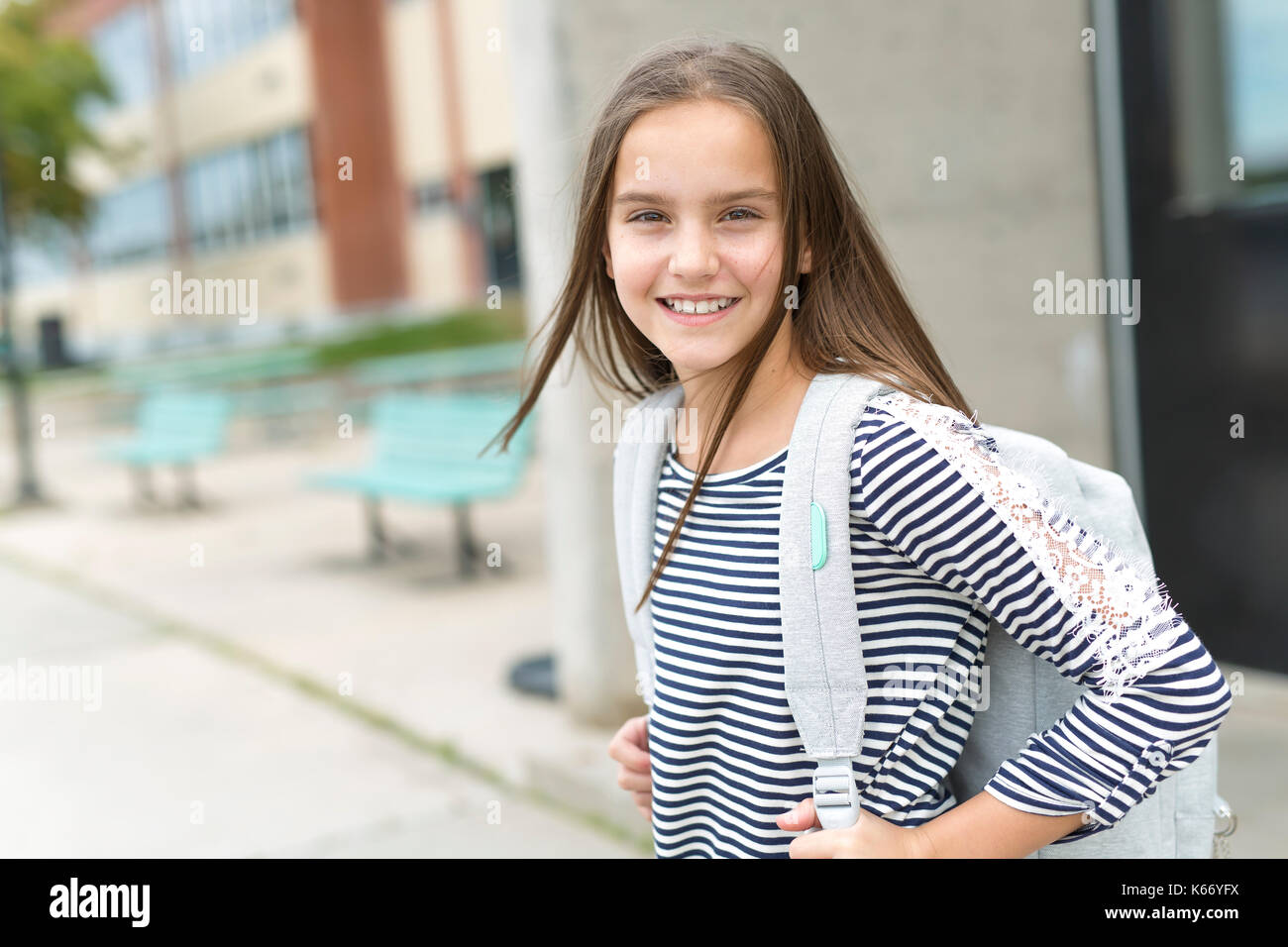 Elementary school pupil outside carrying rucksack Stock Photo - Alamy