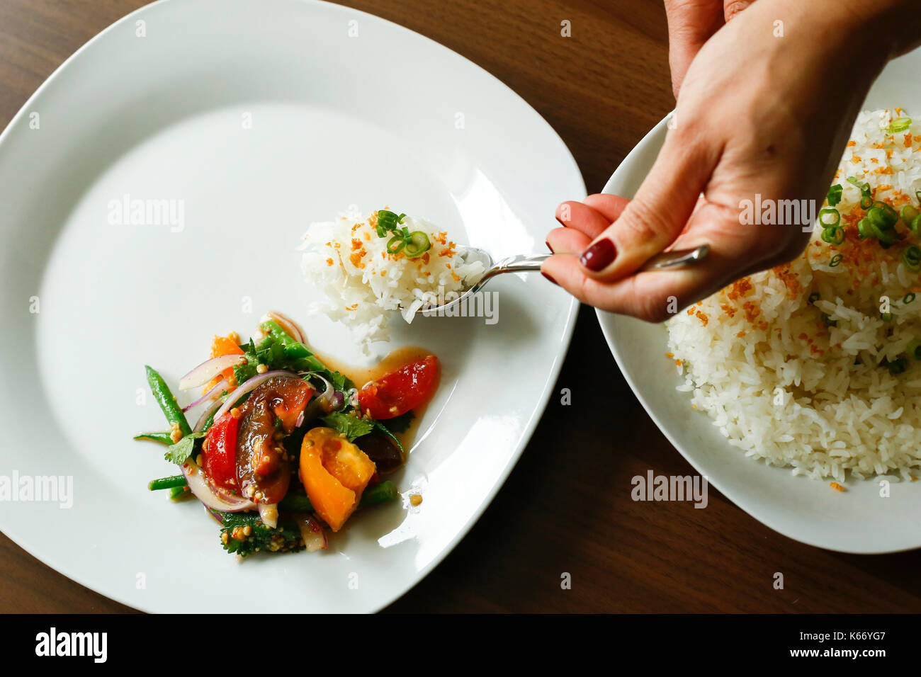 Hands of woman serving rice Stock Photo - Alamy