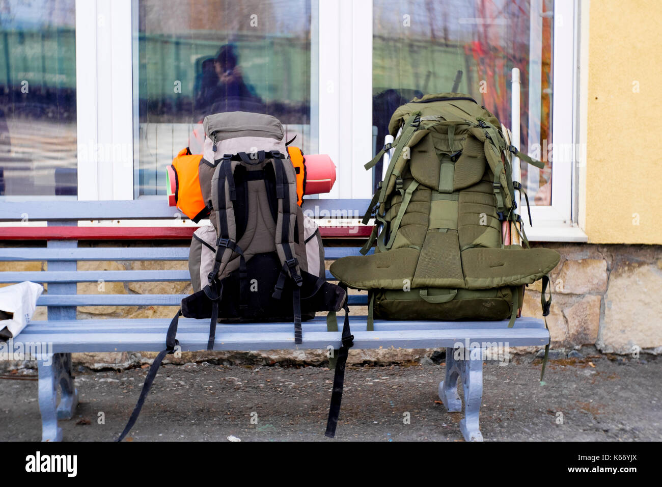 Backpacks on bench Stock Photo - Alamy