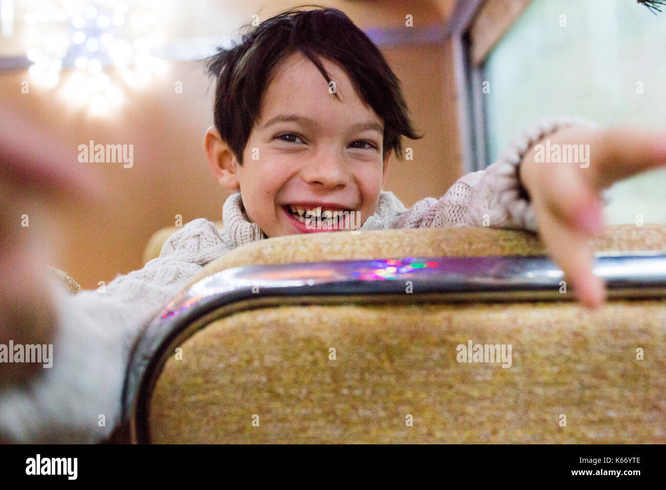 Mixed Race by reaching over seat on train Stock Photo - Alamy