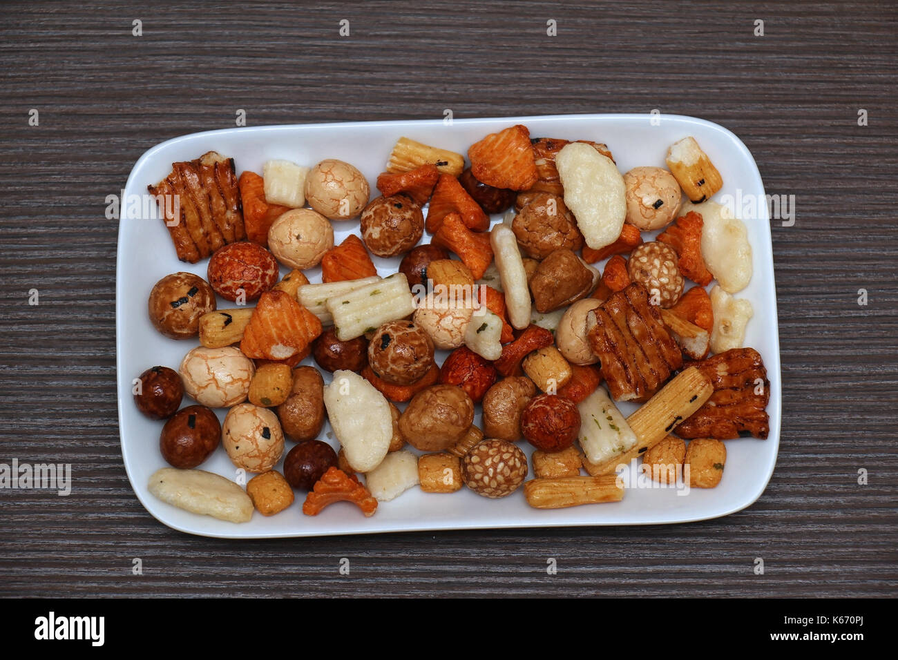 Japanese salty rice snacks in ceramic plate Stock Photo - Alamy